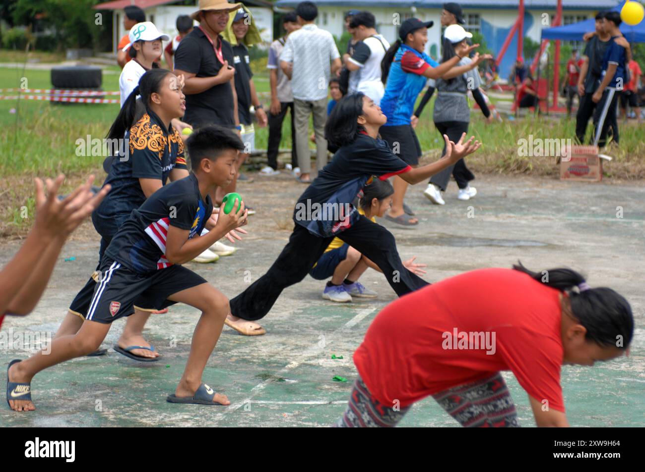 Water balloon catching game, during a community event at Bongkud, Ranau ...
