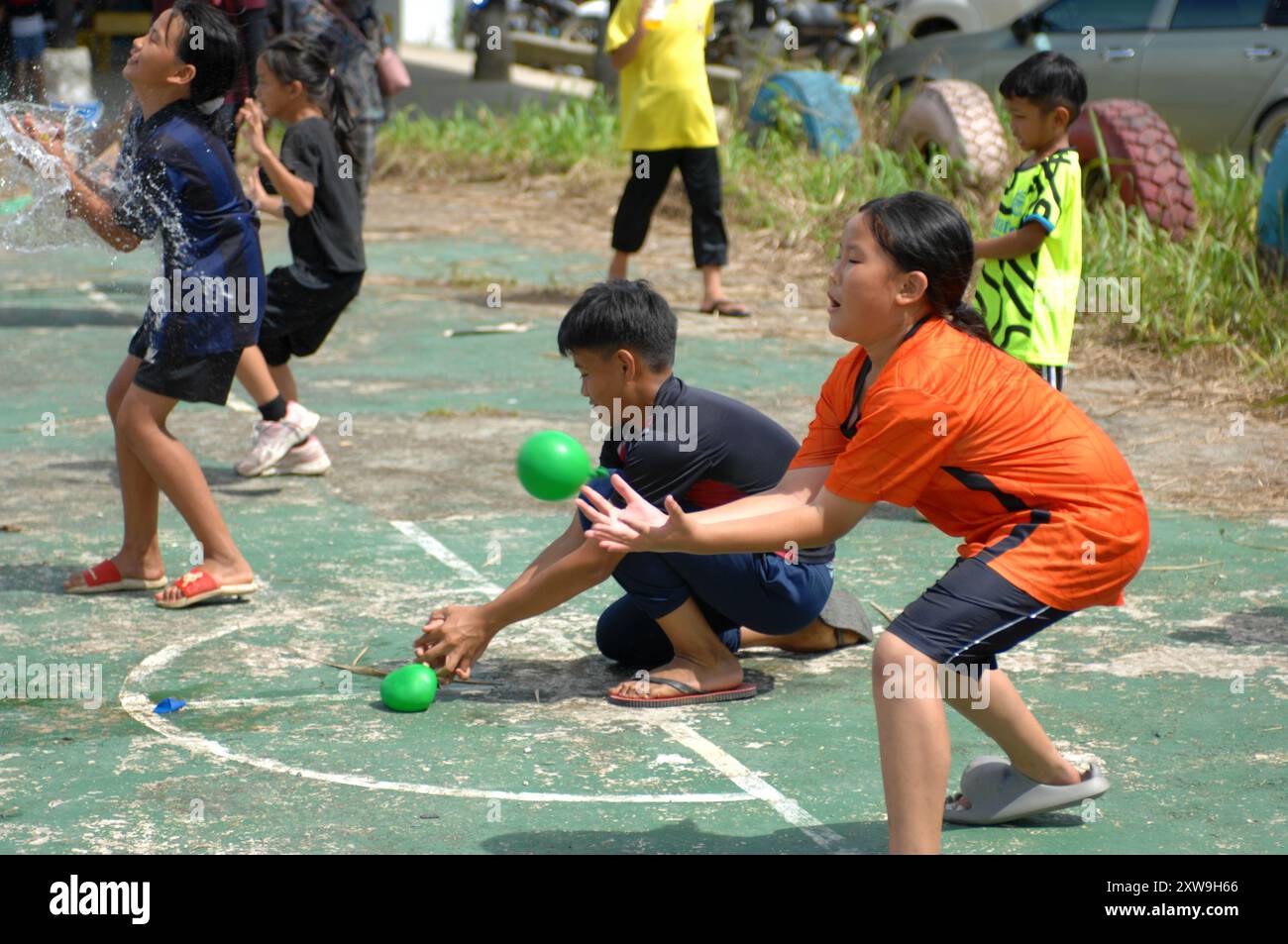 Water balloon catching game, during a community event at Bongkud, Ranau ...
