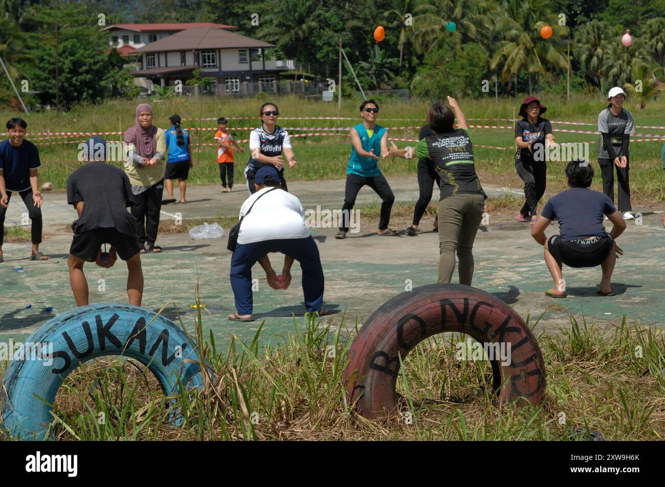 Water balloon catching game, during a community event at Bongkud, Ranau ...