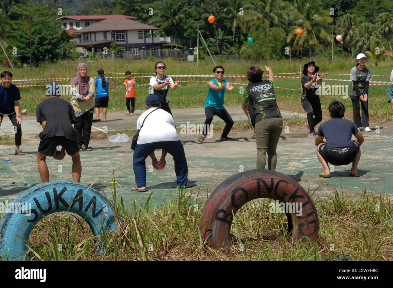 Water balloon catching game, during a community event at Bongkud, Ranau ...