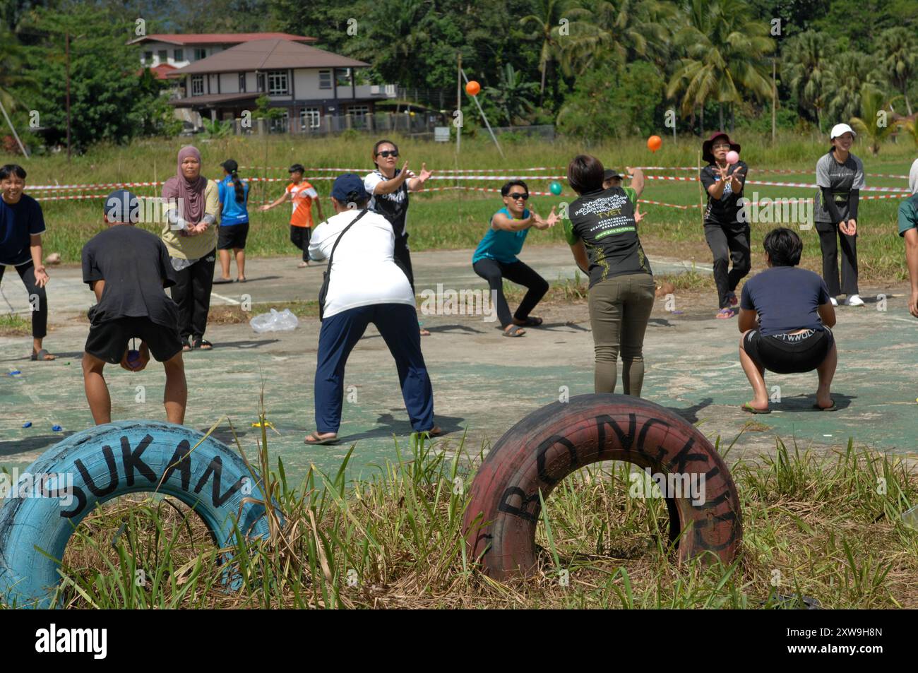 Water balloon catching game, during a community event at Bongkud, Ranau ...