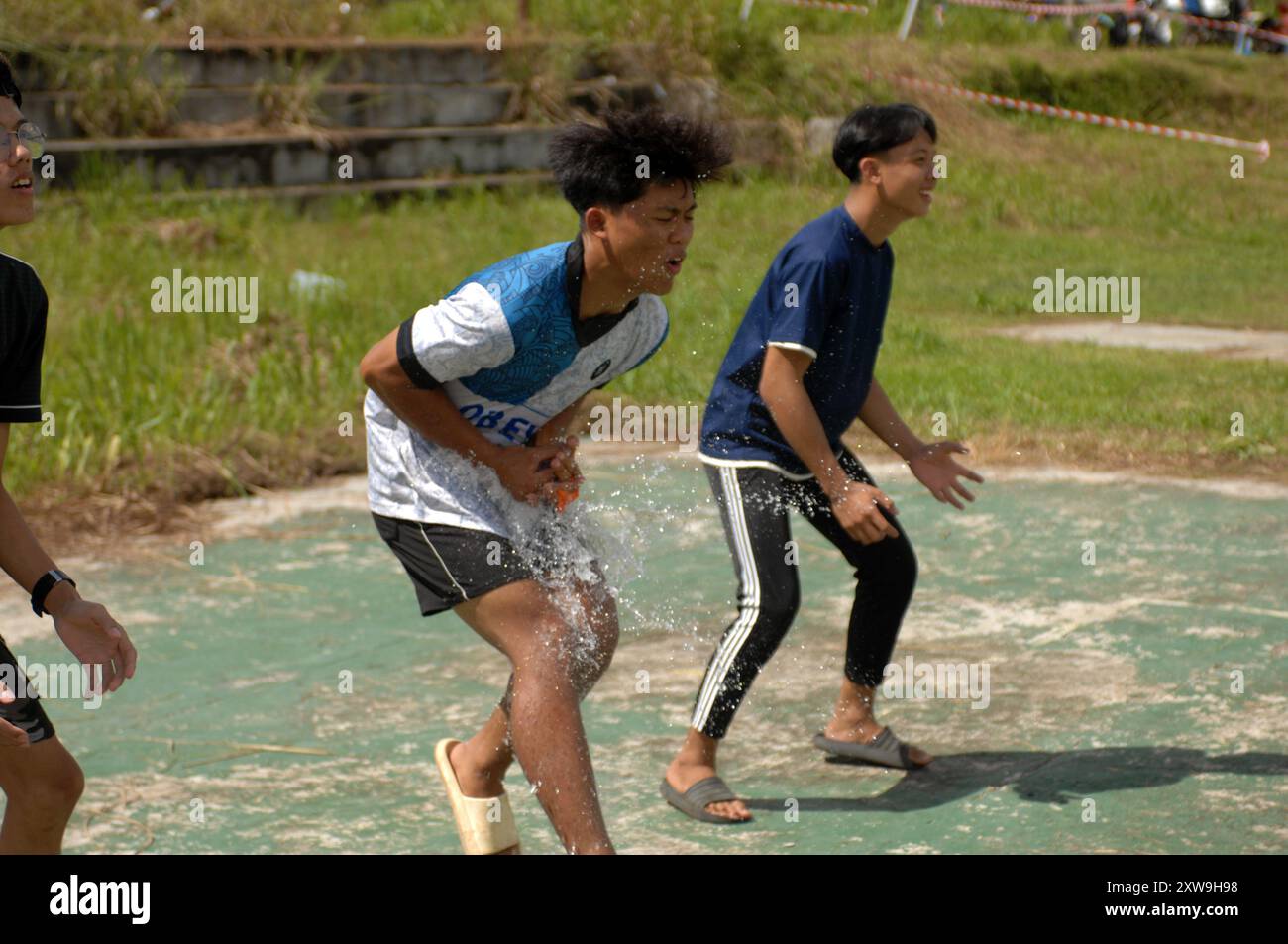Water balloon catching game, during a community event at Bongkud, Ranau ...