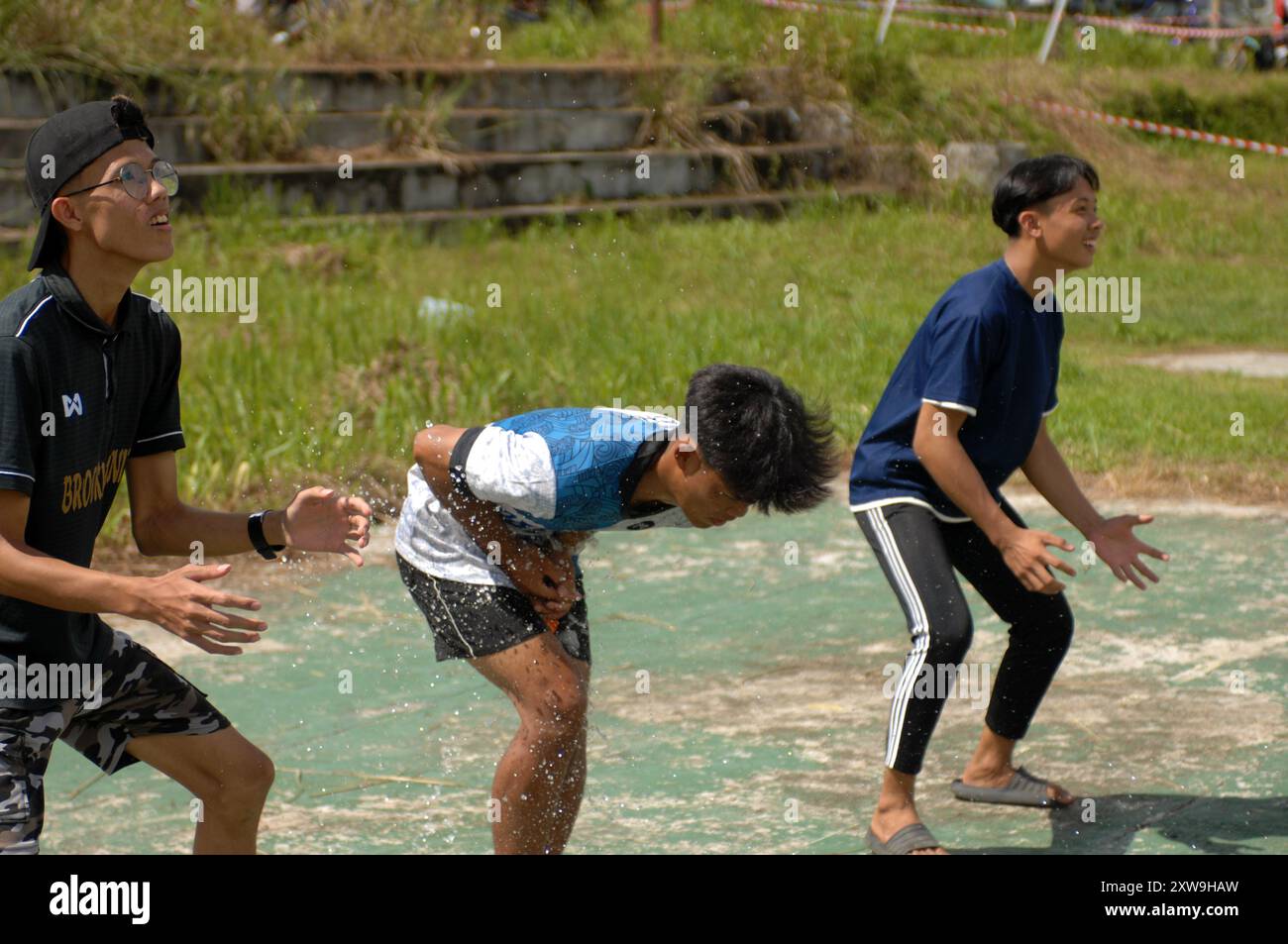 Water balloon catching game, during a community event at Bongkud, Ranau ...