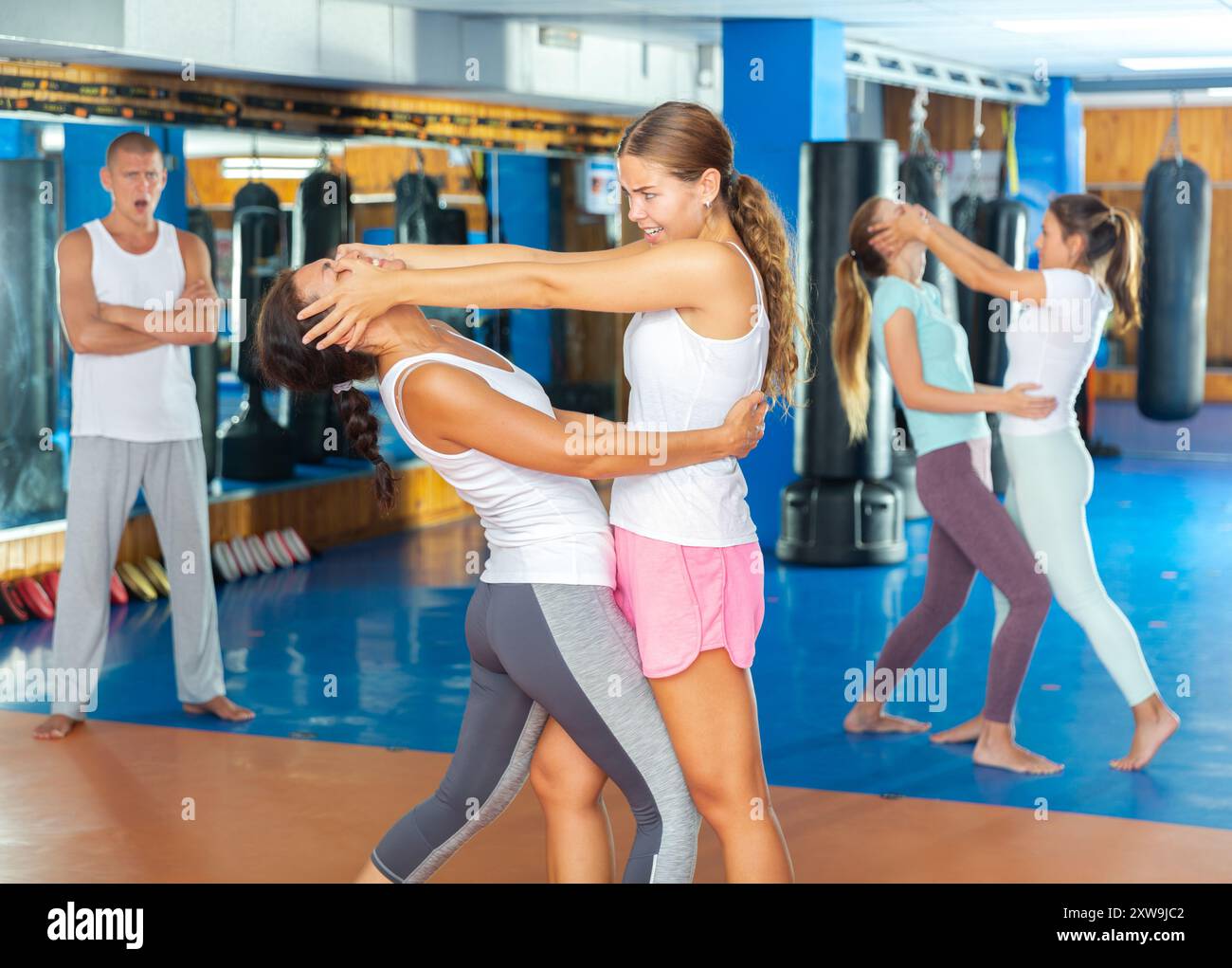 Sporty girls in pairs are training self-defence moves Stock Photo - Alamy