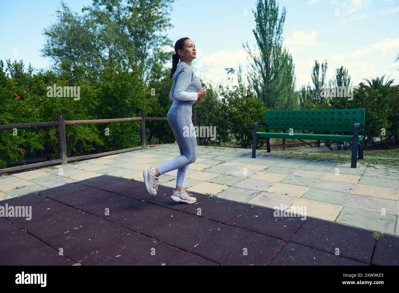 Woman jogging in park, embracing outdoor exercise and fitness ...