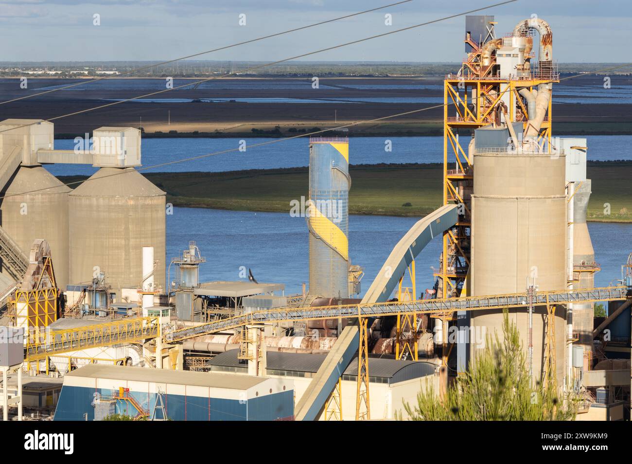Cement factory with conveyor belts transporting raw materials with a ...