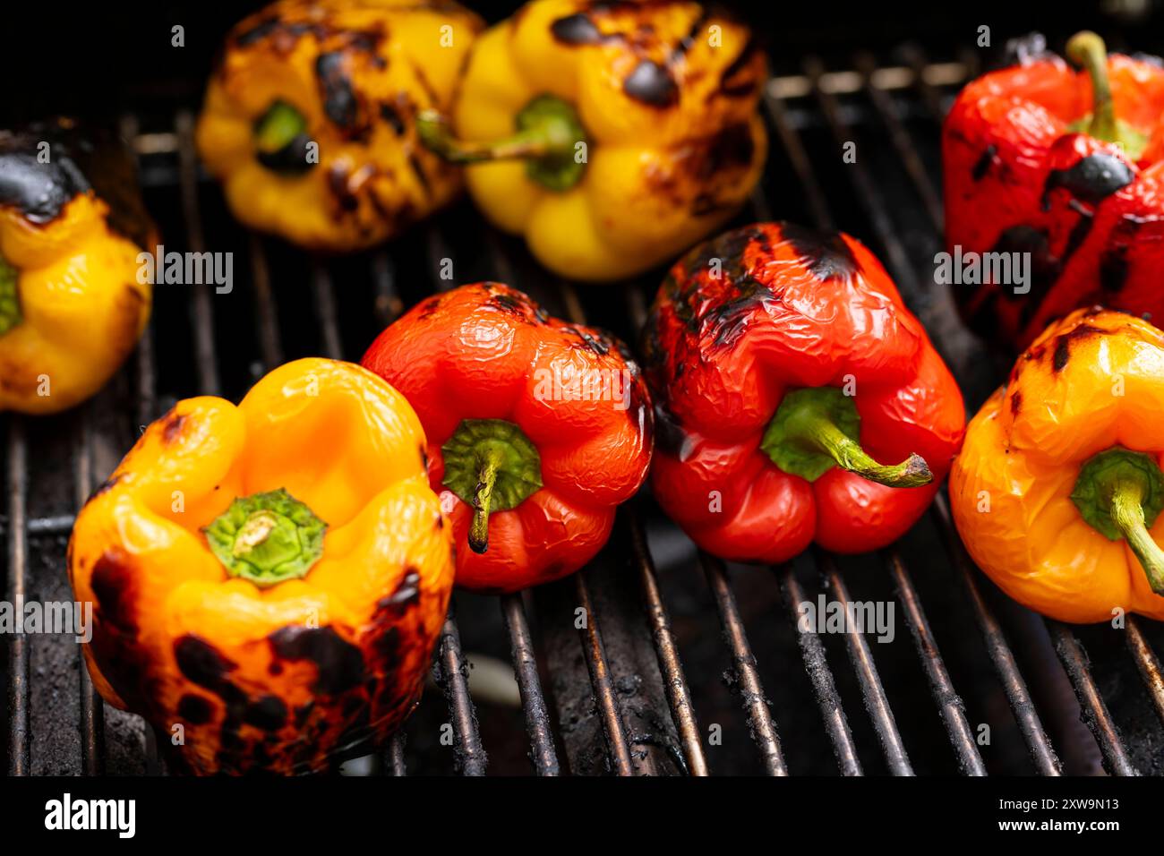 Red and yellow grilled pepper on BBQ fireplace Stock Photo - Alamy