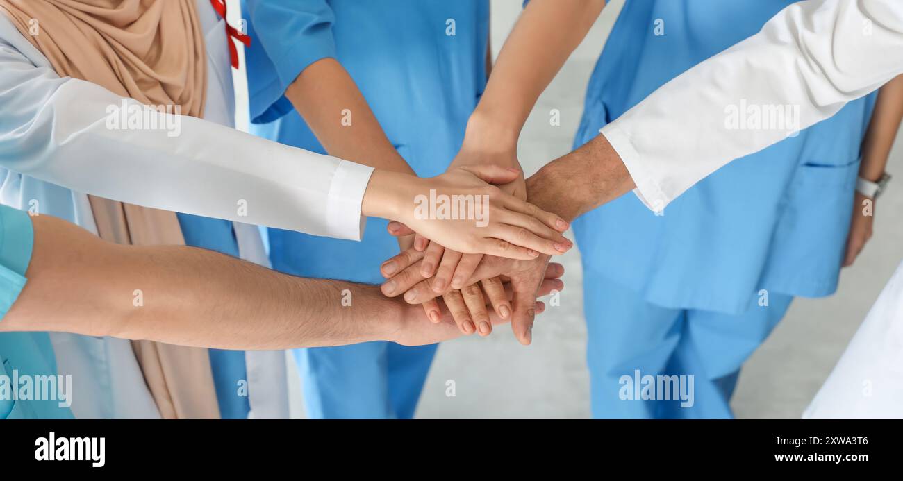 Team of doctors putting hands together, closeup. Unity concept Stock ...