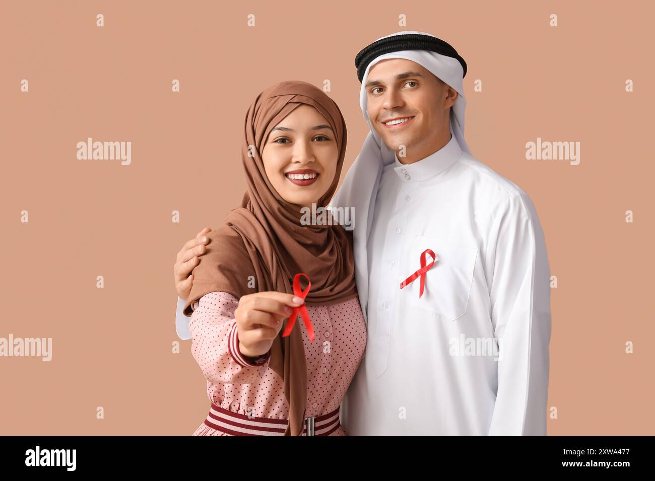 Beautiful Muslim couple with red ribbons on brown background. AID ...