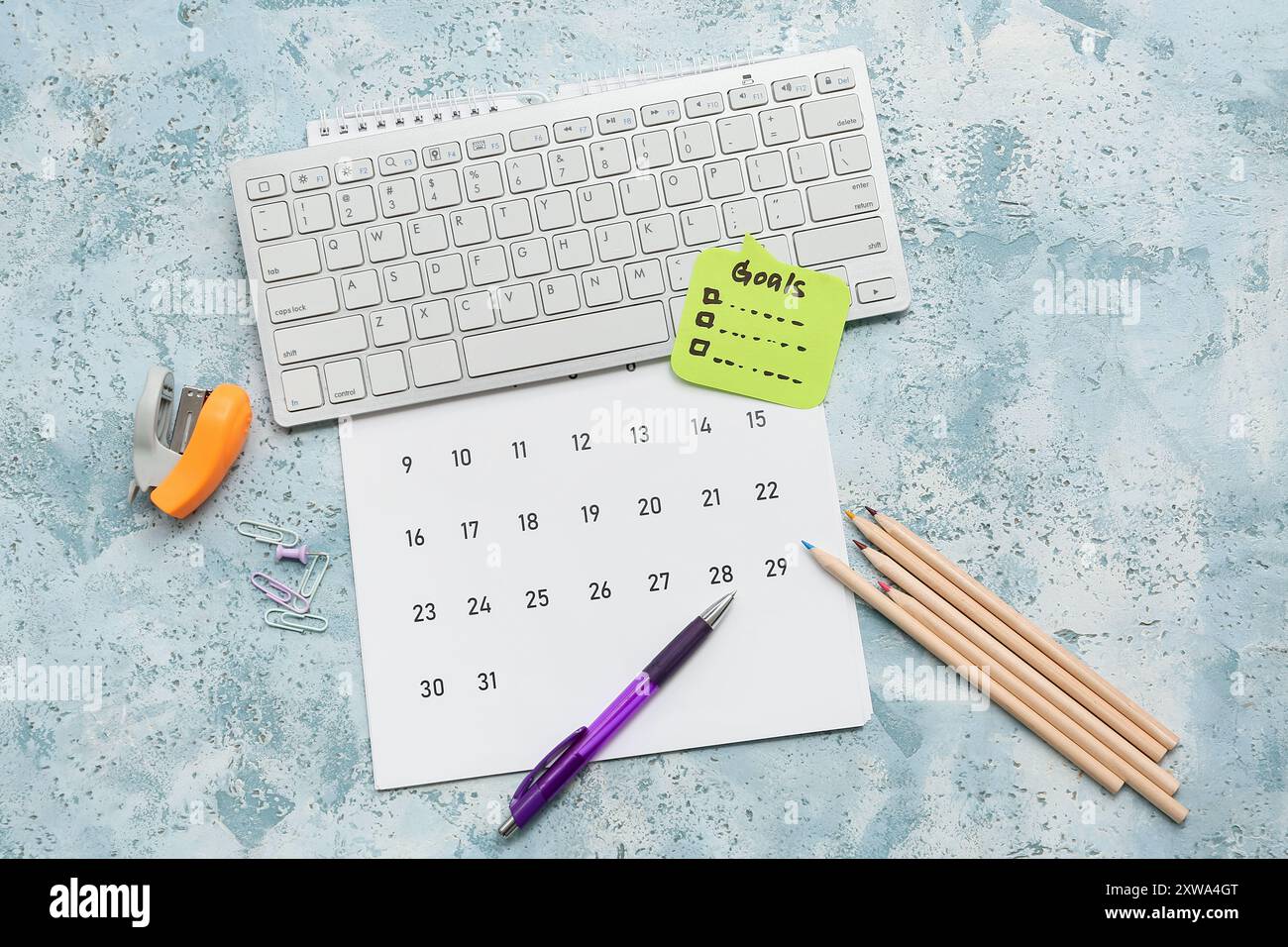 Sticky note with to do plans, computer keyboard and calendar on blue ...