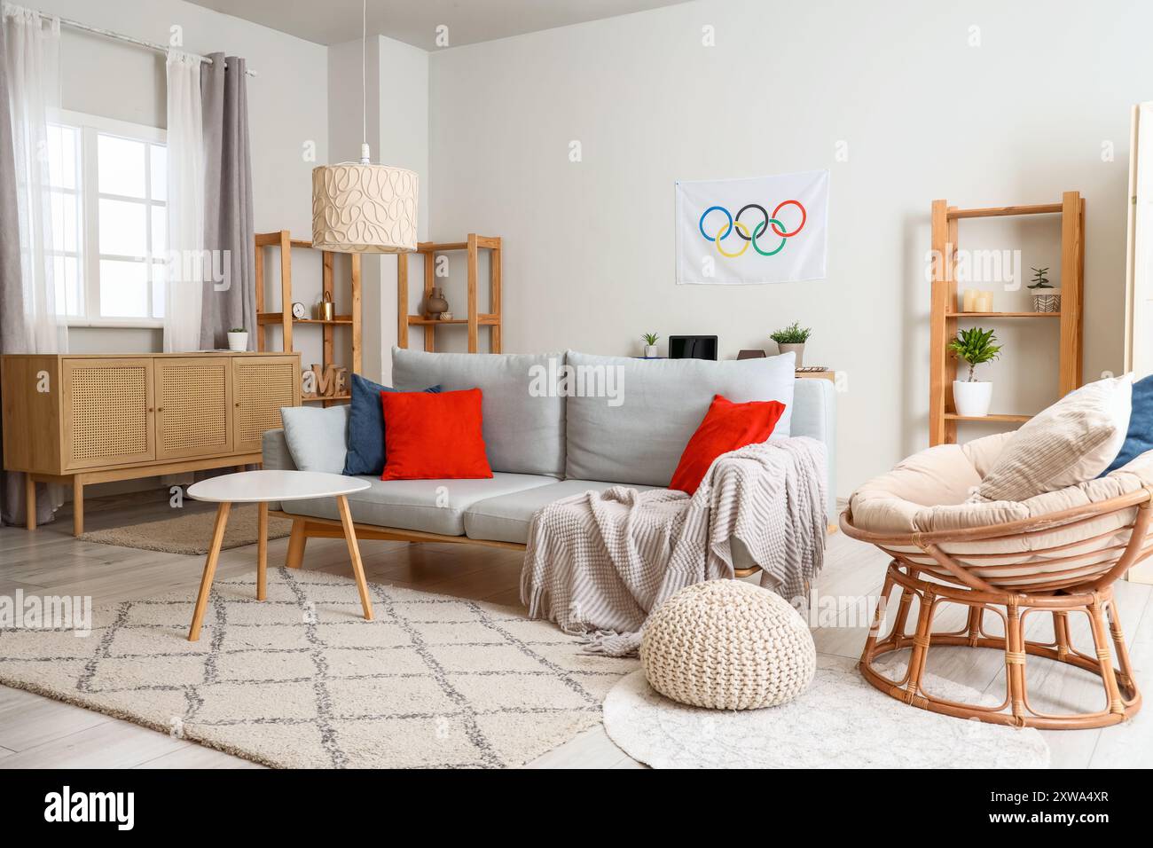 Interior of living room with grey sofa, armchair, coffee table and ...