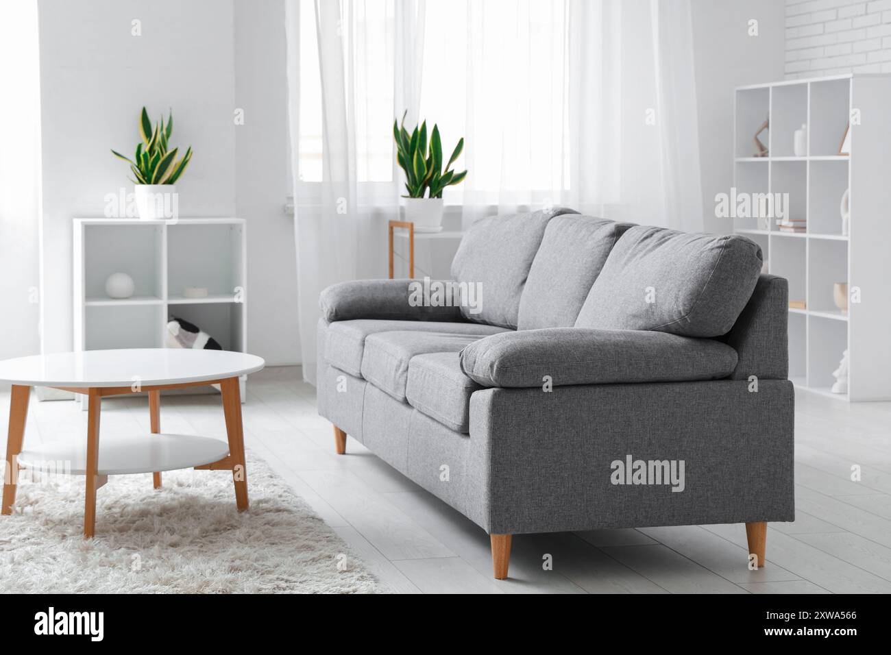 Comfortable sofa and coffee table in interior of living room Stock ...