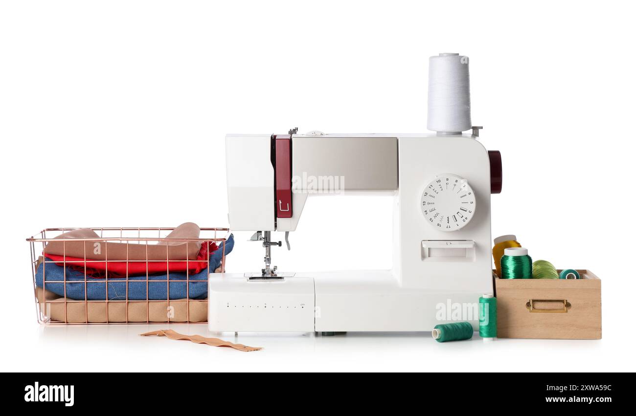Modern sewing machine with tailor's supplies isolated on white ...