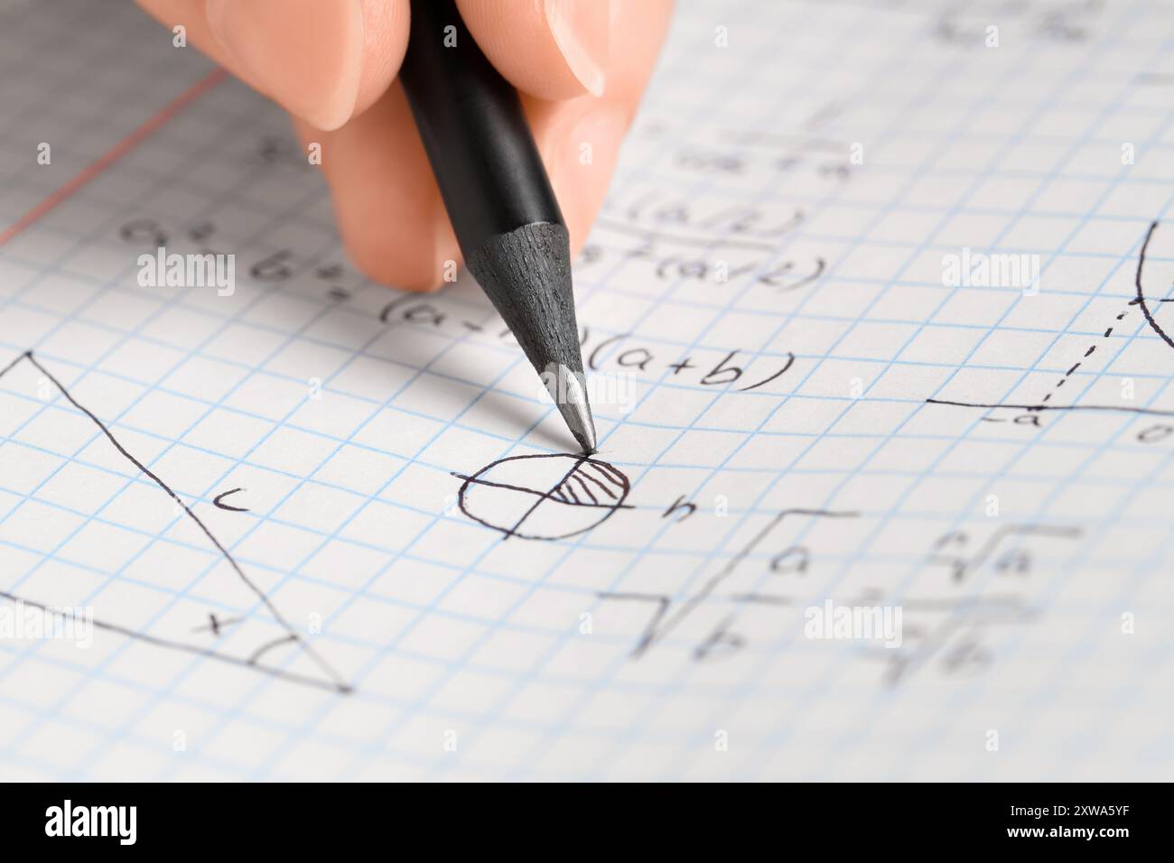 Female hand writing maths formulas in copybook, closeup Stock Photo - Alamy