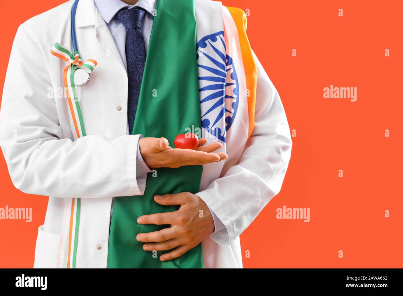 Male physician with flag of India, ribbon and heart on orange ...