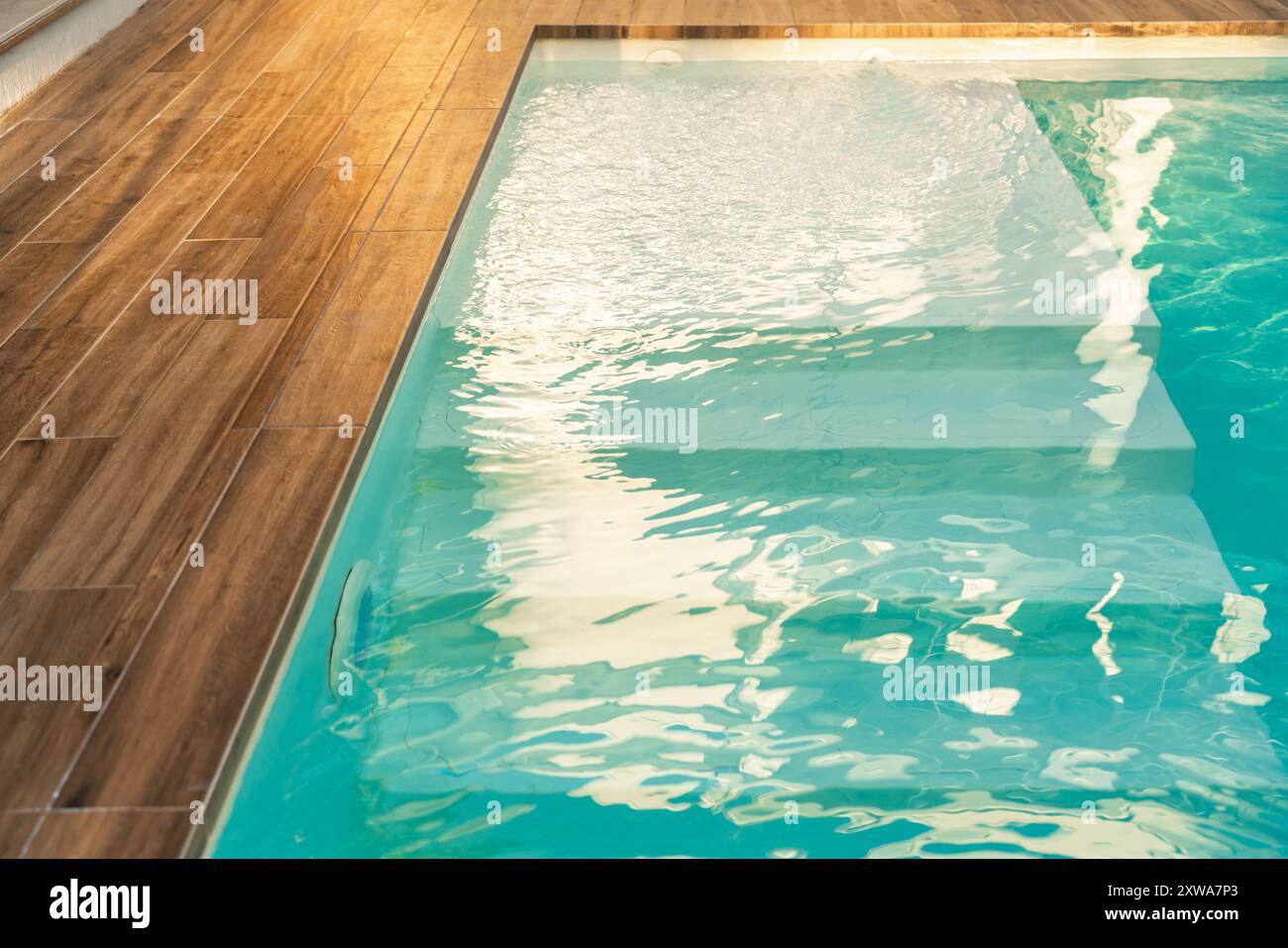 Swimming pool entrance steps with clean blue water at modern villa ...