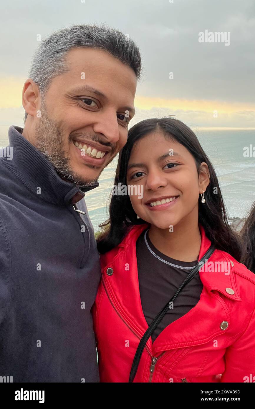 A A father and daughter are smiling for a picture. The man is wearing a ...
