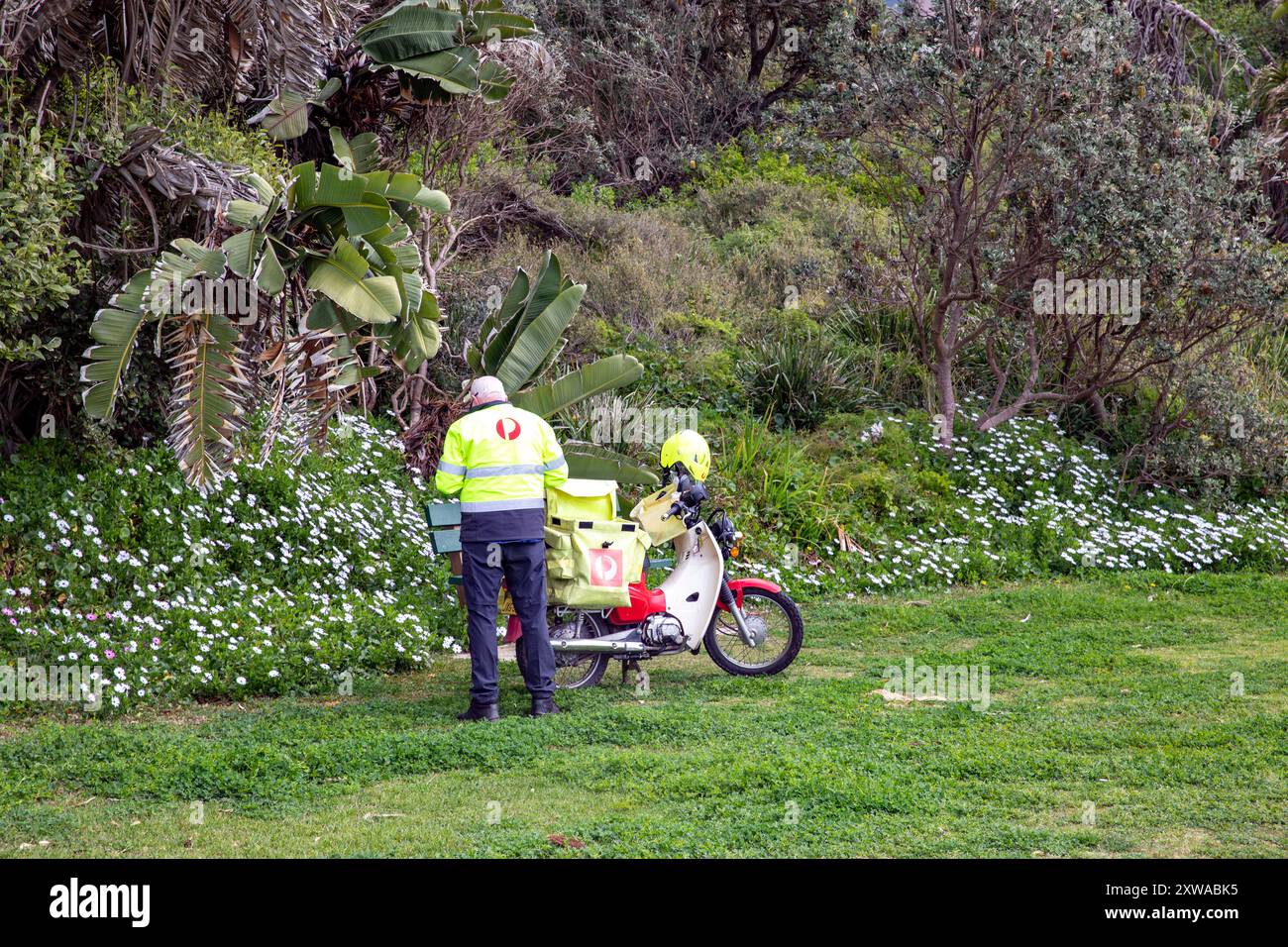 Australian postal worker postman having a lunch break, Sydney,NSW,Australia with postie bike ...