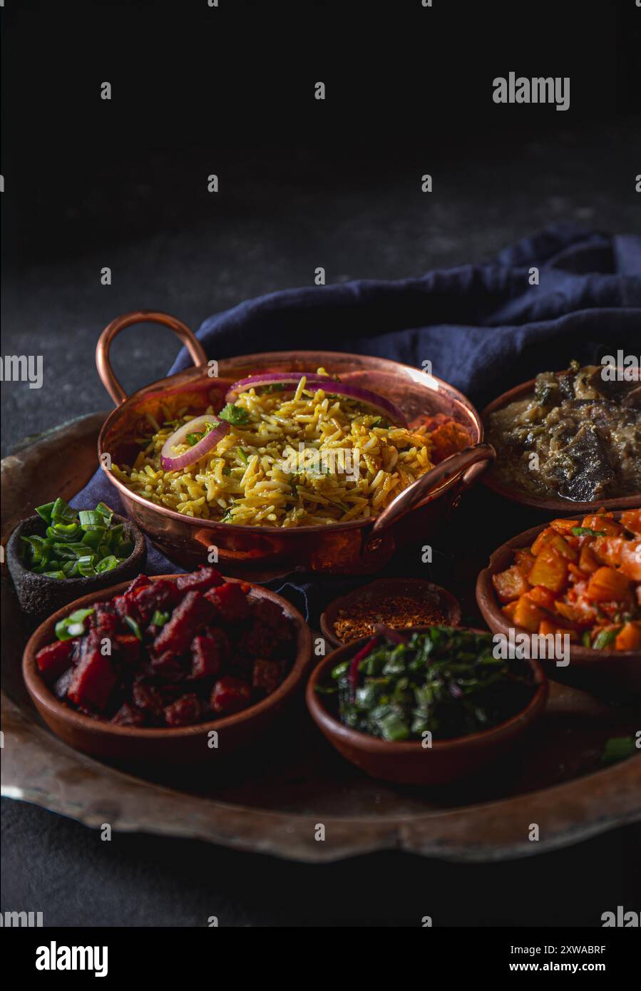 A plate featuring rice biryani and a variety of vegetarian Indian and ...