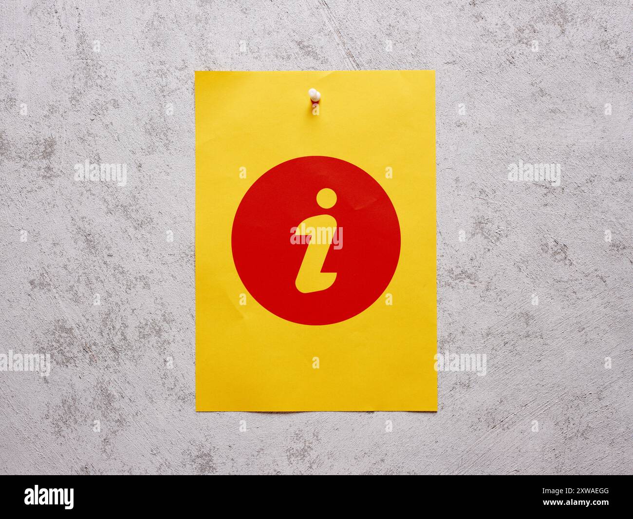 Information info sign on a yellow sheet of paper pinned to a white ...