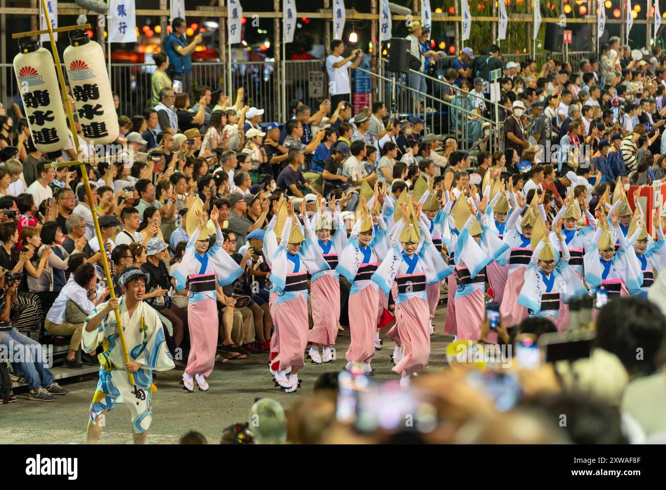 Tokushima Awa Odori Festival 2024. Performers wear traditional costumes, dance and sing in a ...
