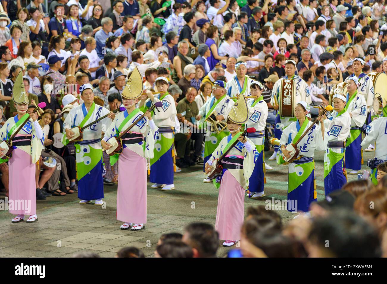 Tokushima Awa Odori Festival 2024. Performers wear traditional costumes, dance and sing in a ...