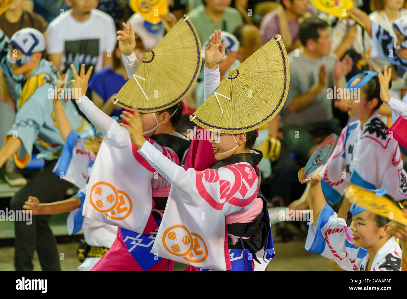 Tokushima Awa Odori Festival 2024. Performers wear traditional costumes, dance and sing in a ...