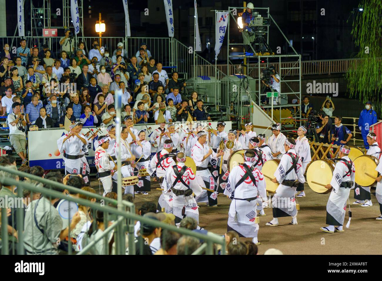 Tokushima Awa Odori Festival 2024. Performers wear traditional costumes, dance and sing in a ...