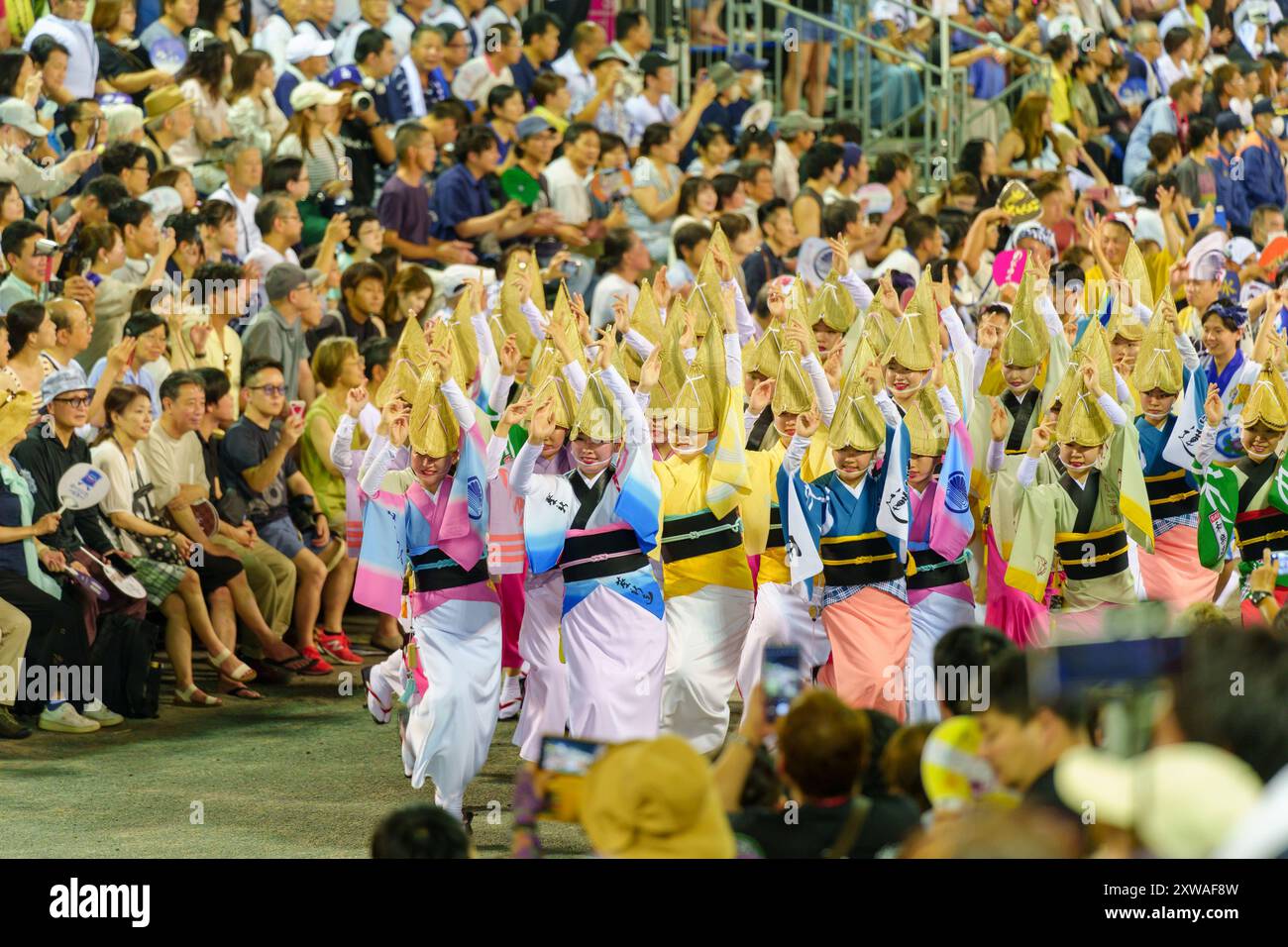 Tokushima Awa Odori Festival 2024. Performers wear traditional costumes, dance and sing in a ...