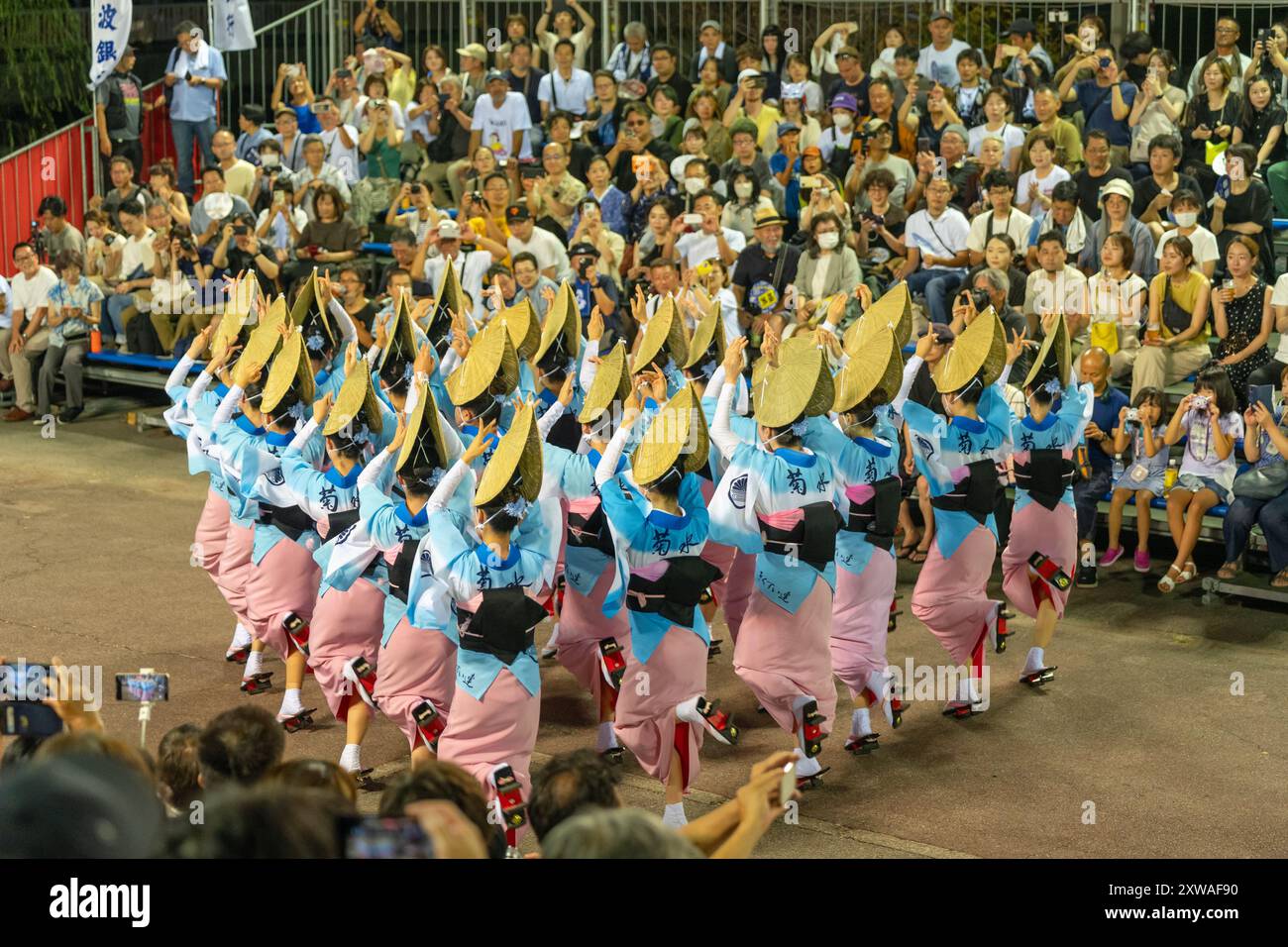 Tokushima Awa Odori Festival 2024. Performers wear traditional costumes, dance and sing in a ...