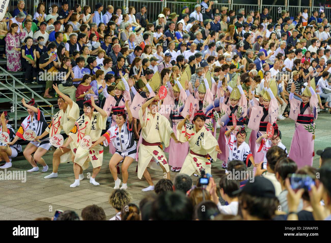 Tokushima Awa Odori Festival 2024. Performers wear traditional costumes, dance and sing in a ...