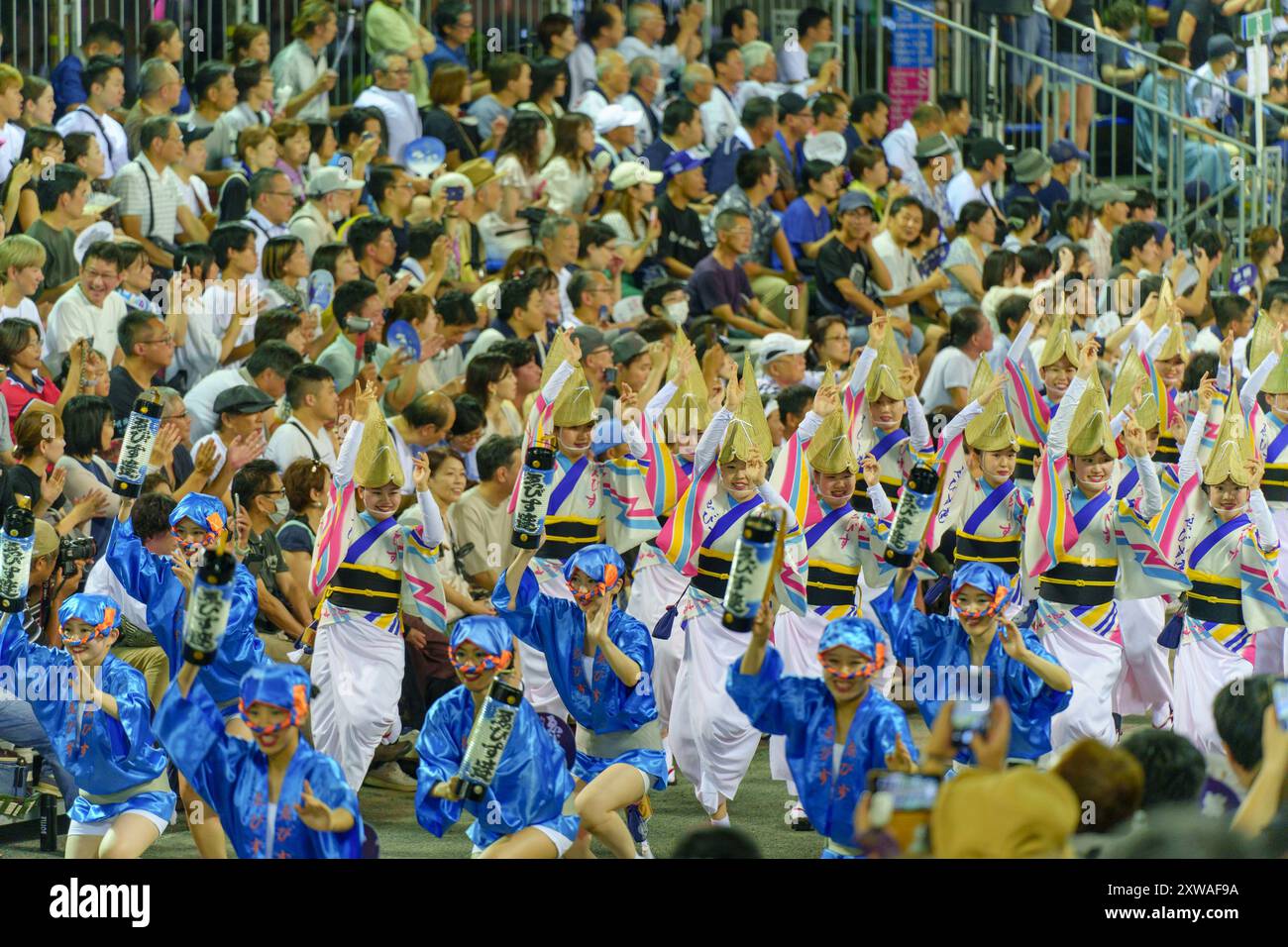 Tokushima Awa Odori Festival 2024. Performers wear traditional costumes, dance and sing in a ...