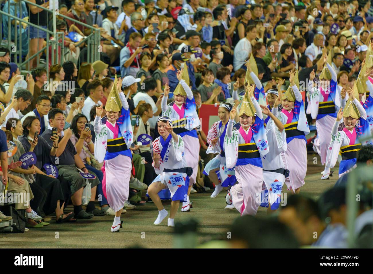 Tokushima Awa Odori Festival 2024. Performers wear traditional costumes, dance and sing in a ...