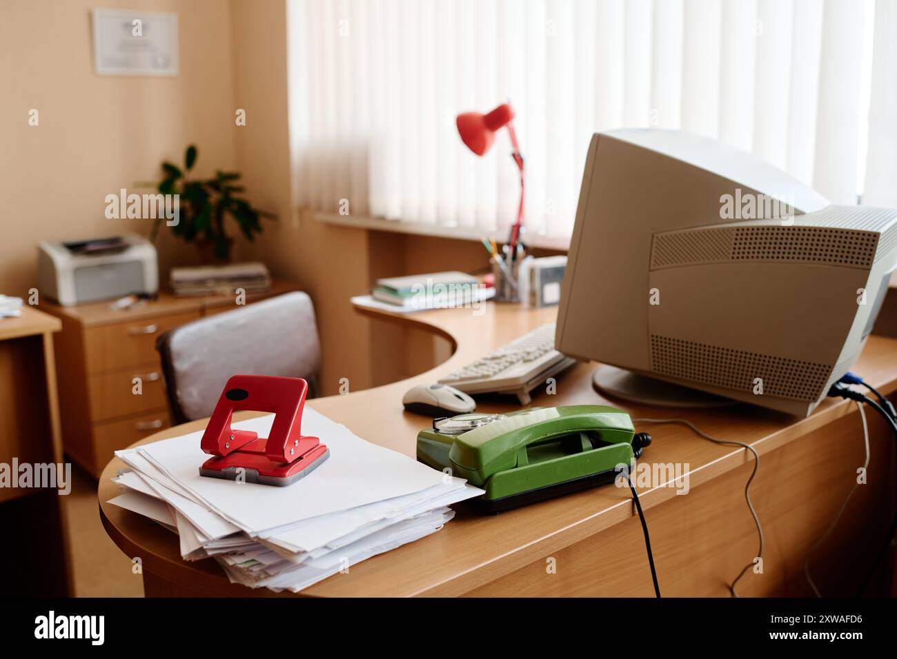 Traditional office desk with neatly organized supplies, featuring an ...