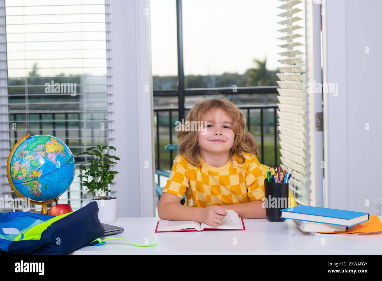 Child reading book. Nerd school kid doing homework at home. Clever ...