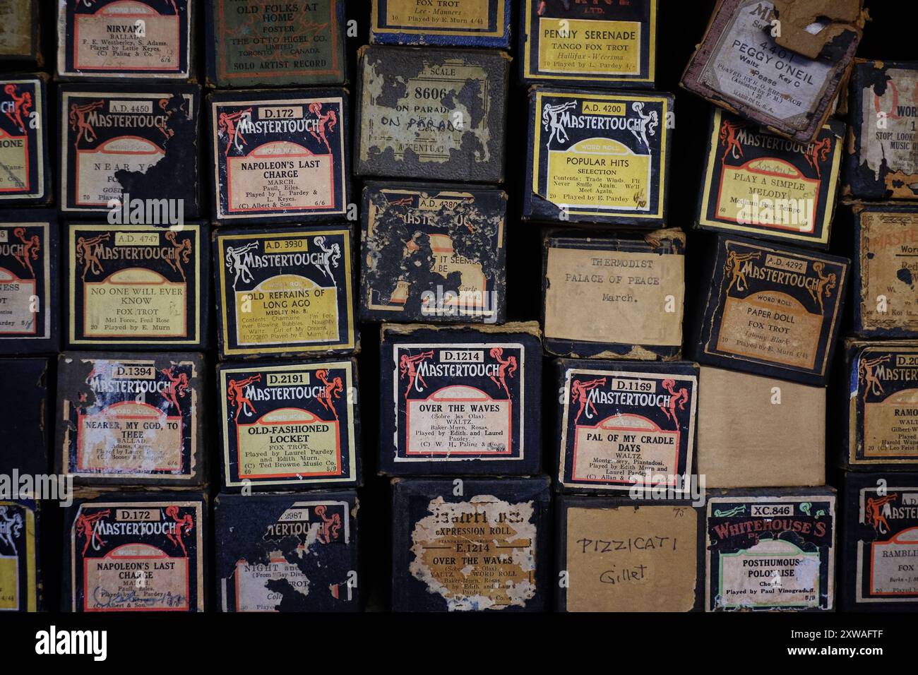 Player piano, pianola rolls, labels on the box ends with the names of ...