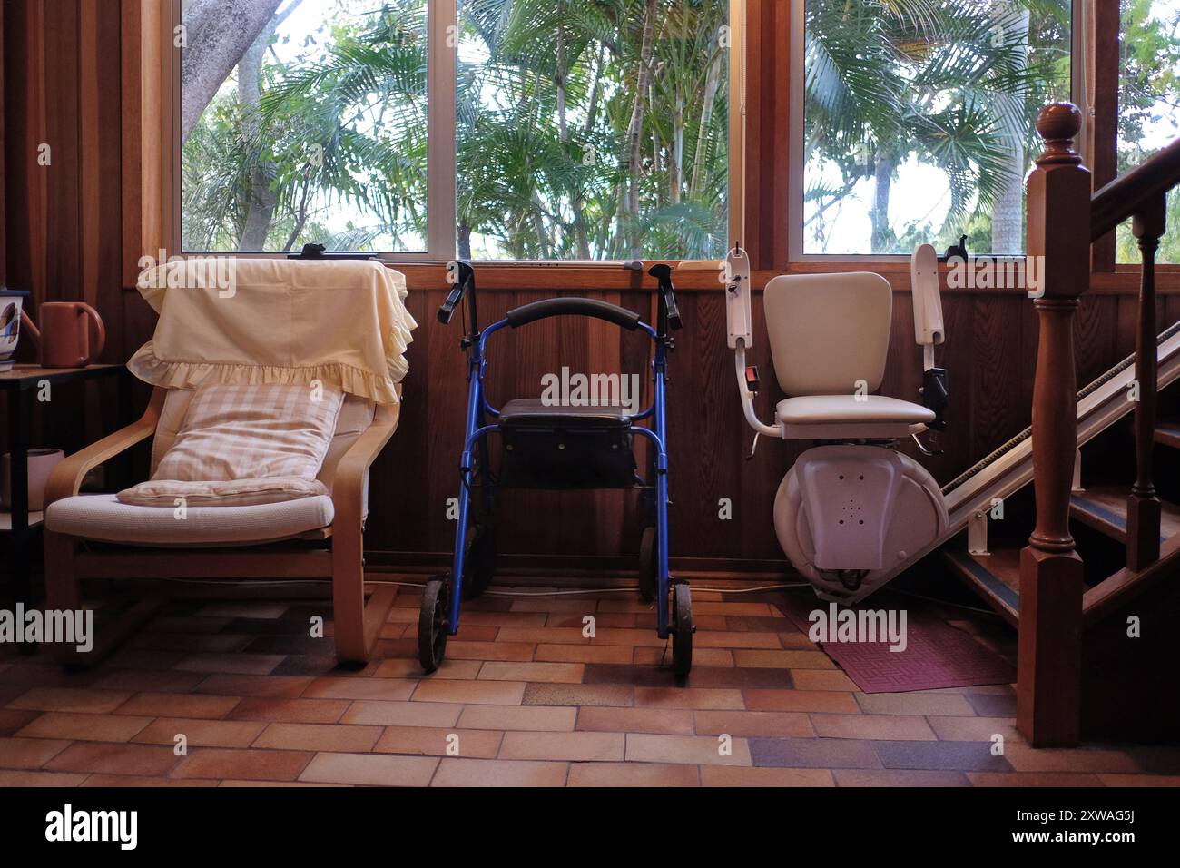 A lounge chair a wheelie walker and stair lift in a row, mobility ...