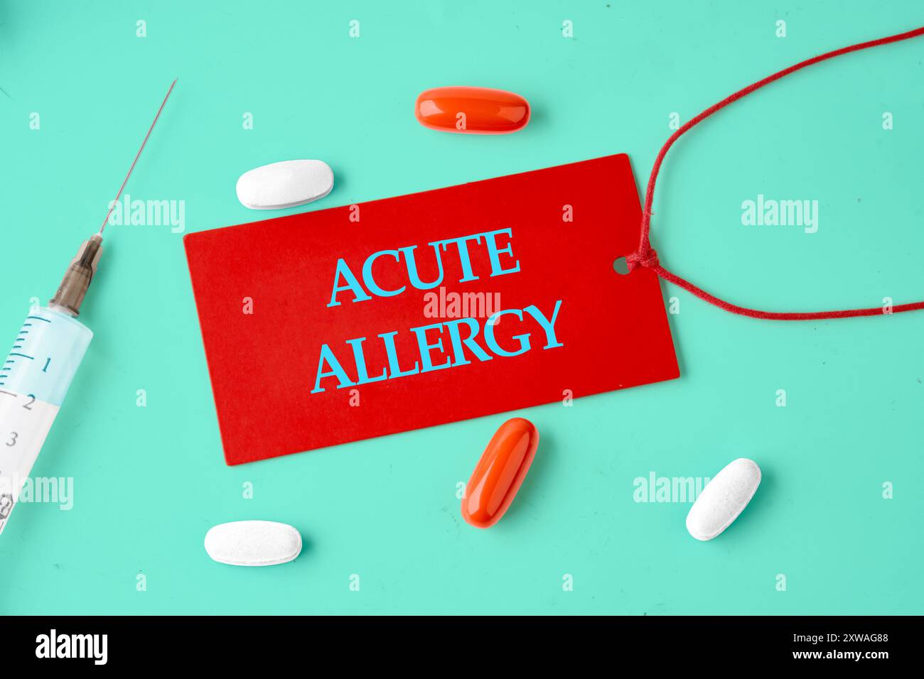 ACUTE ALLERGY words on a red card in a composition with tablets ...