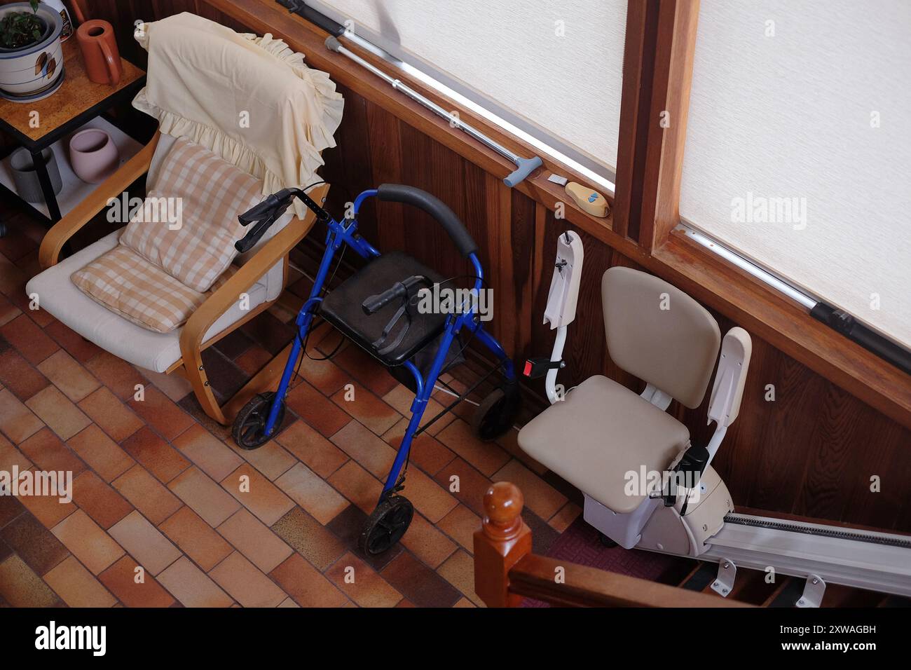 Overhead view of a sunroom with a wheelie walker and stair lift, in a ...