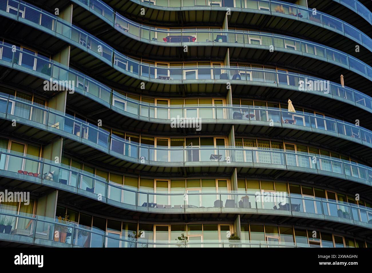 Modern apartment building with curved glass facade. Contemporary ...