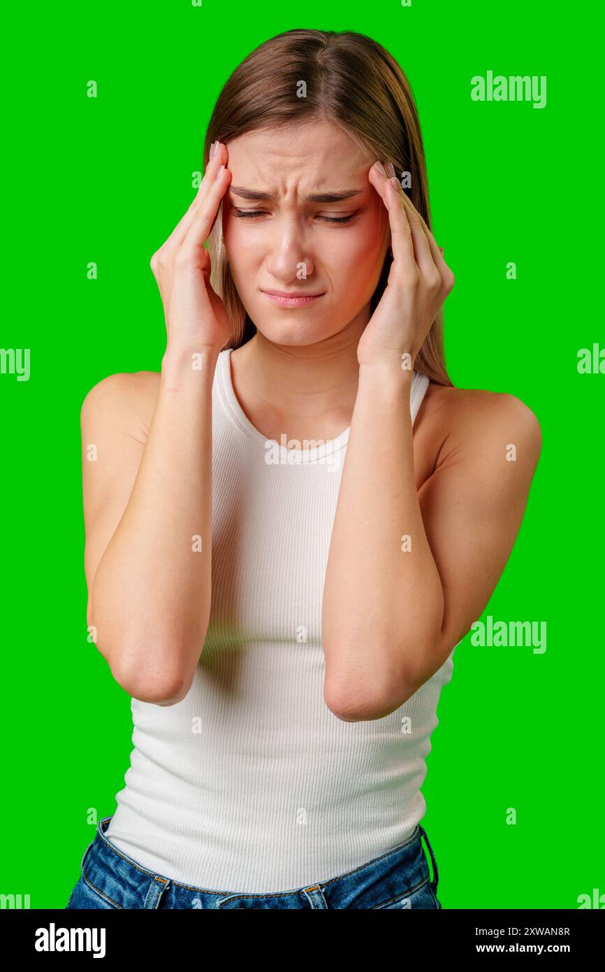 Young Woman Holding Her Head In Pain Against A Green Screen Stock Photo ...