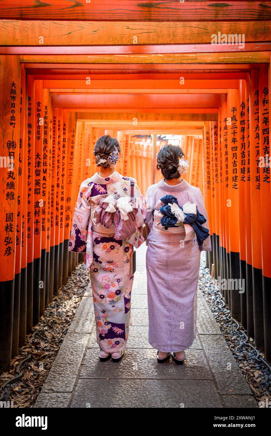 Two women in kimonos are walking in Fushimi Inari Taisha shrine Senbon ...
