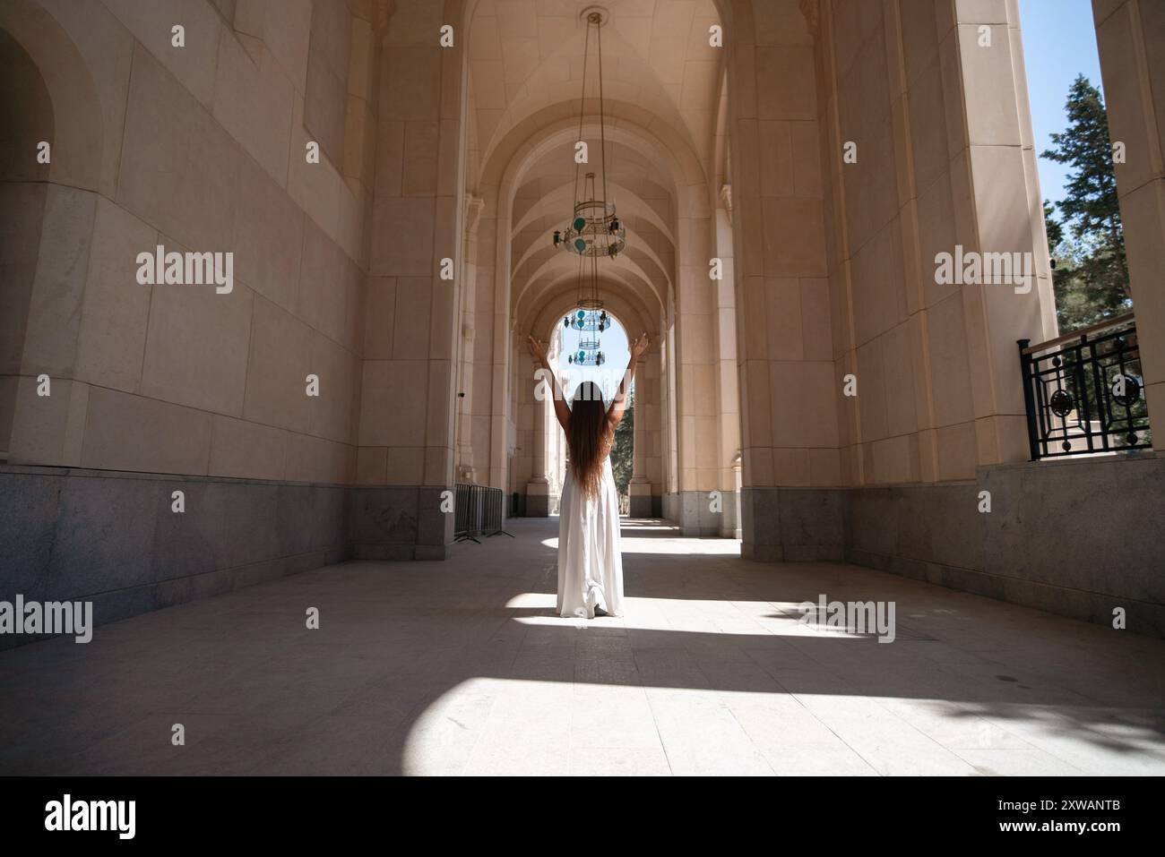 Woman, Arches, Building - A woman in white clothing raises her arms in ...