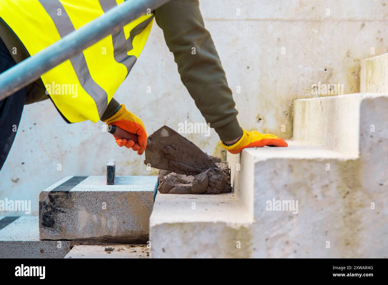 Concrete steps under construction as a team of builders install heavy ...