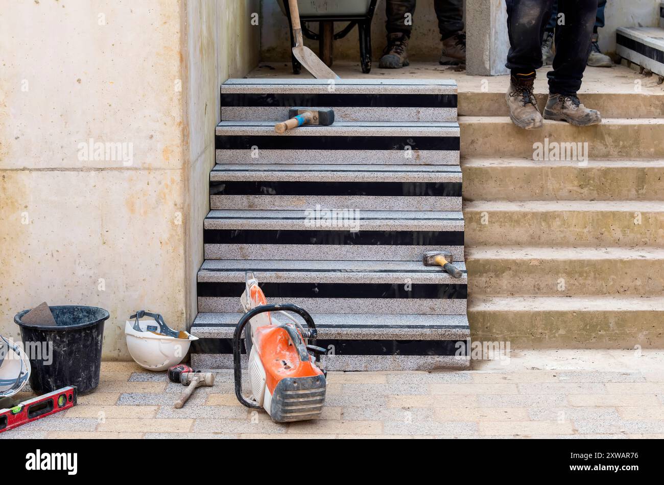 Concrete steps under construction as a team of builders install heavy ...