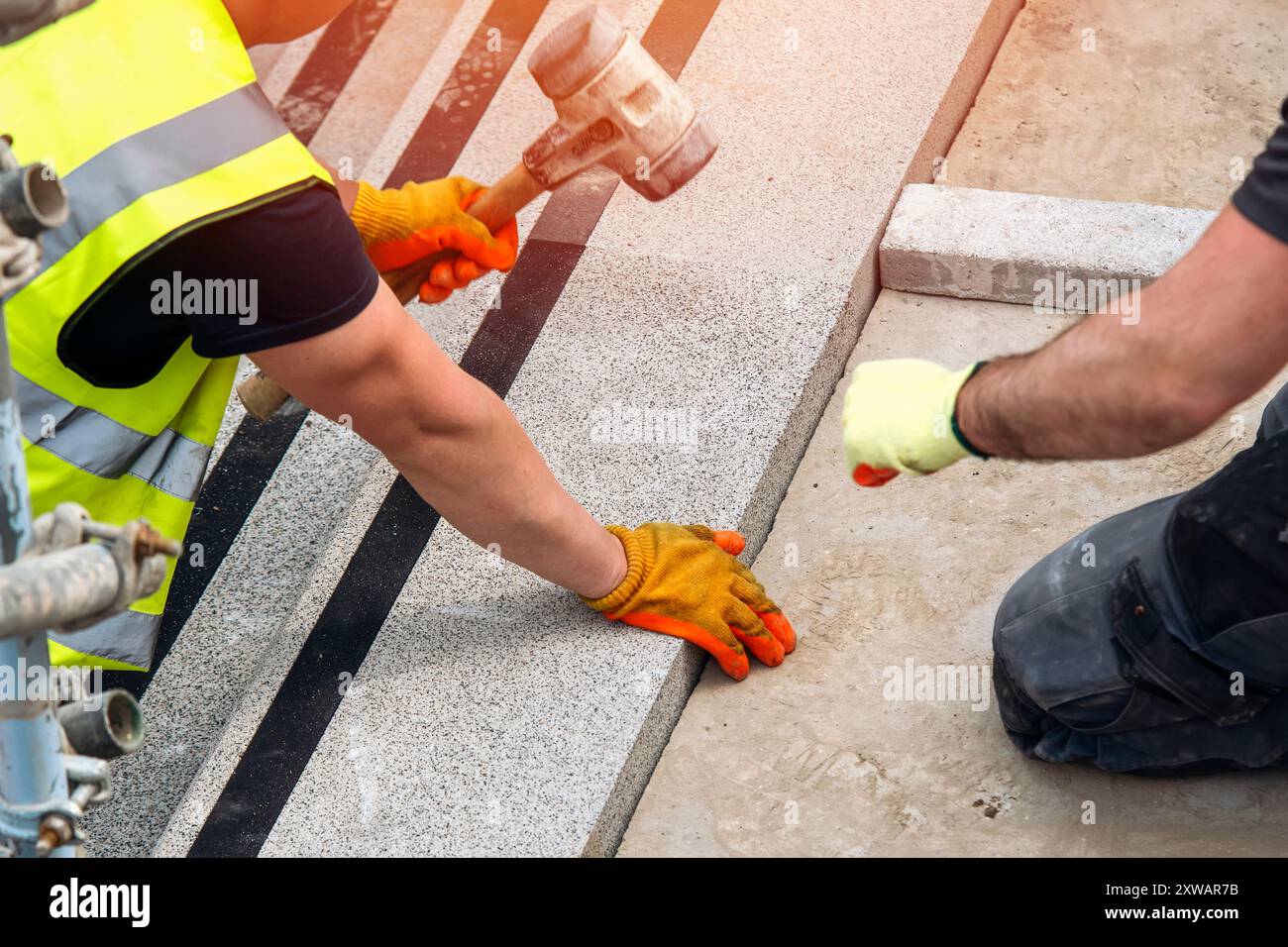 Concrete steps under construction as a team of builders install heavy ...
