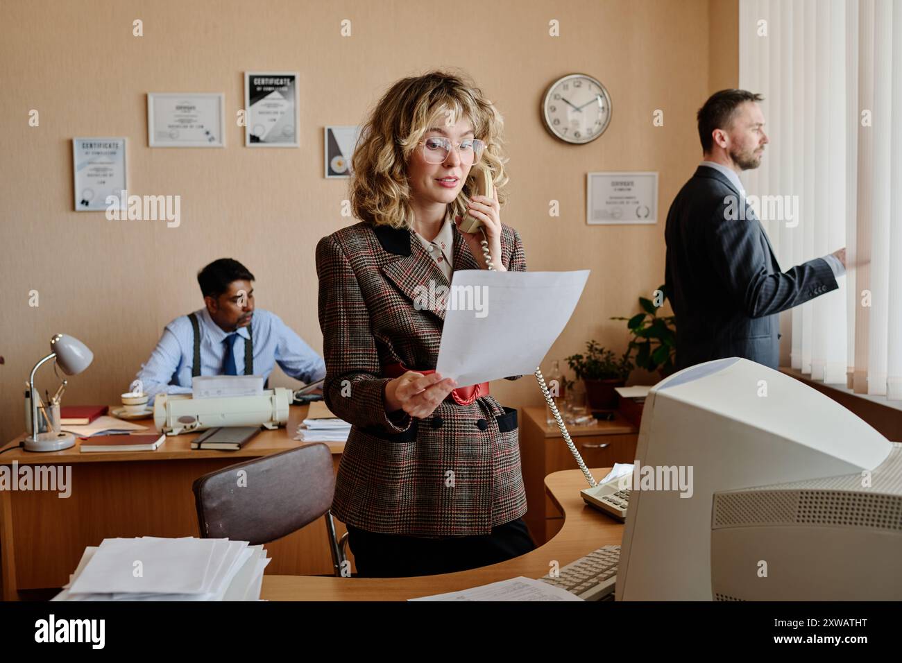 Diverse business team members performing tasks in office workspace ...