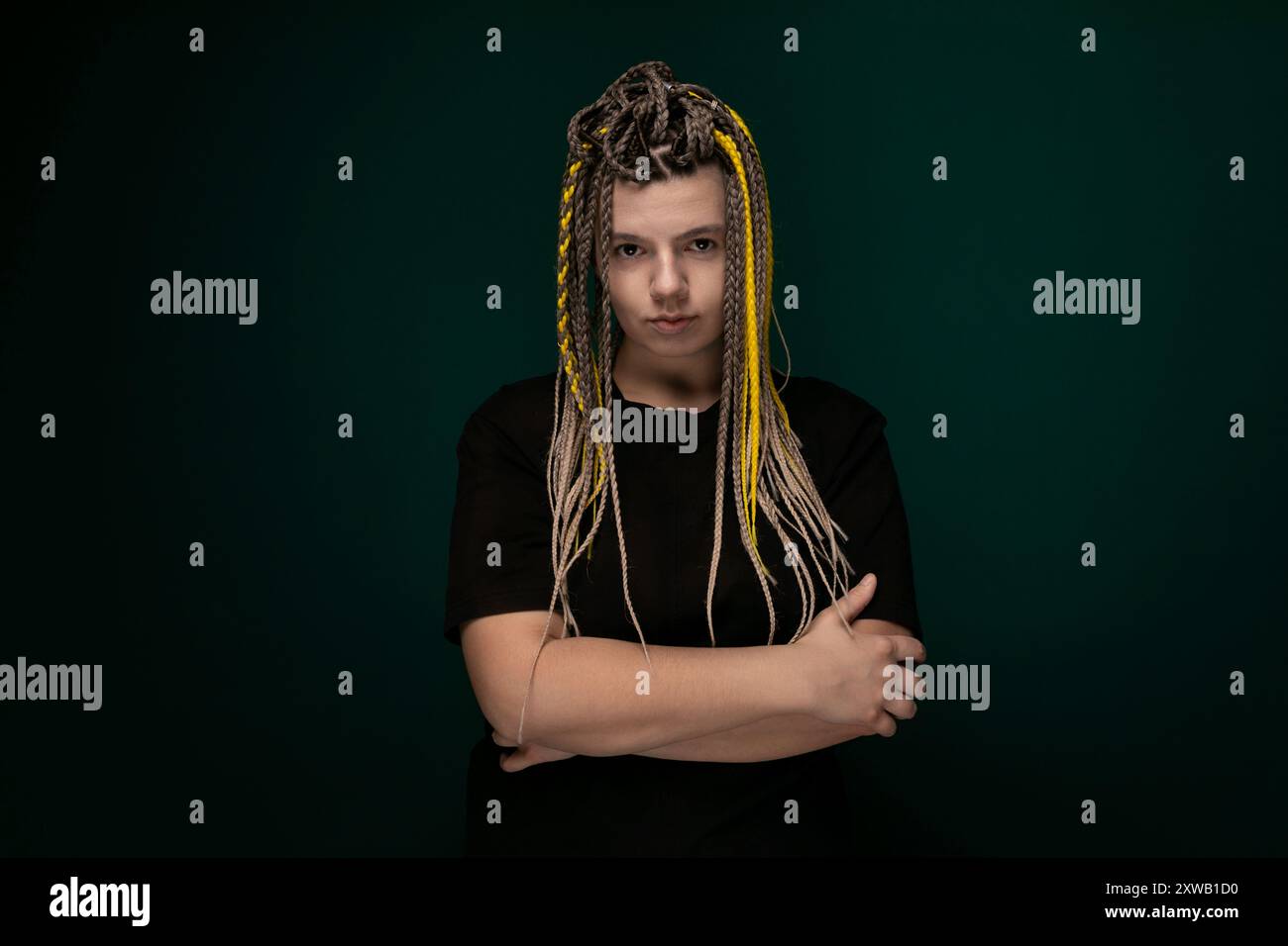 Woman With Yellow Dreadlocks Standing With Arms Crossed Stock Photo - Alamy