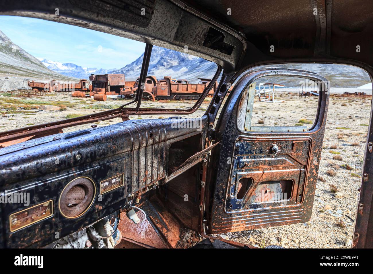 Rusted cars and oil drums from a US airbase from the Second World War ...