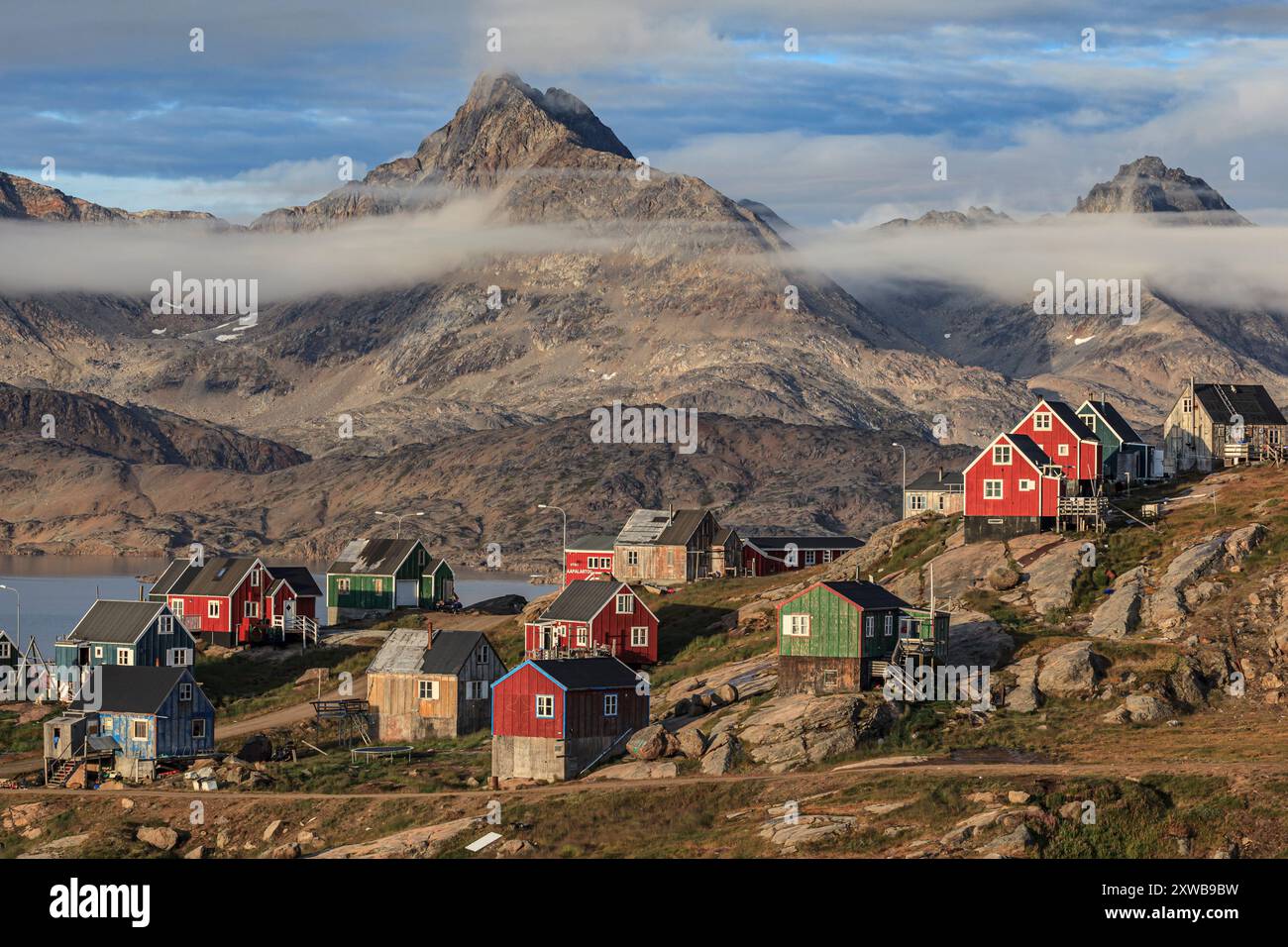 Inuit settlement, typical greenlandic houses at a fjord with mountains ...